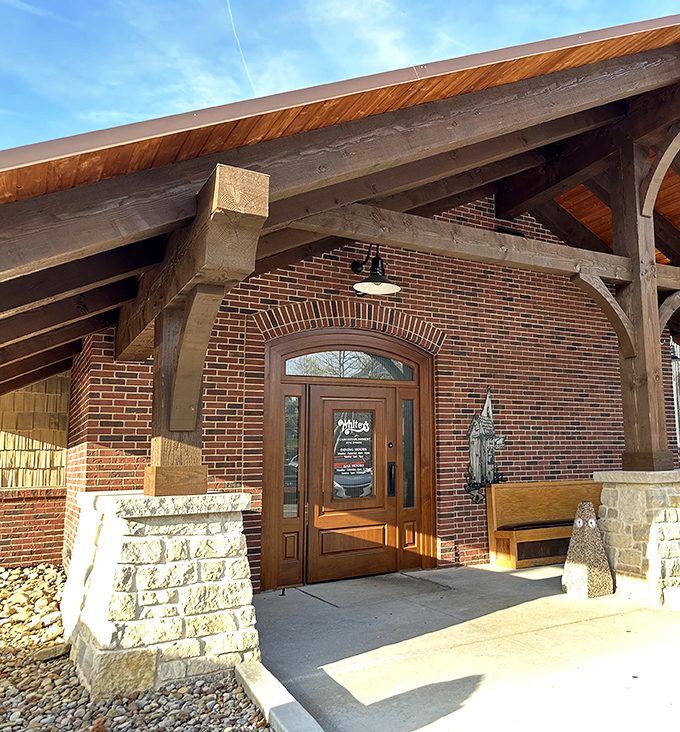 The welcoming entrance to Whitey's features rustic timber beams and warm brick, like a modern lodge that happens to serve incredible burgers.