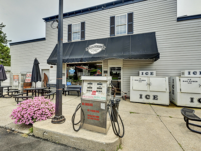 The classic white clapboard exterior of Deersville General Store stands like a time capsule, complete with vintage gas pump and ice chests that promise sweet relief on hot Ohio afternoons.