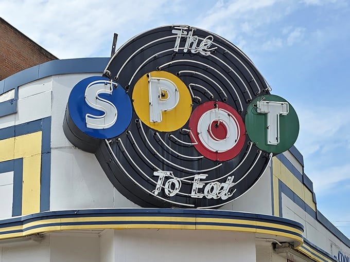 The iconic neon sign of The Spot beckons hungry travelers with its colorful circles &ndash; a retro beacon of comfort food promising in downtown Sidney.