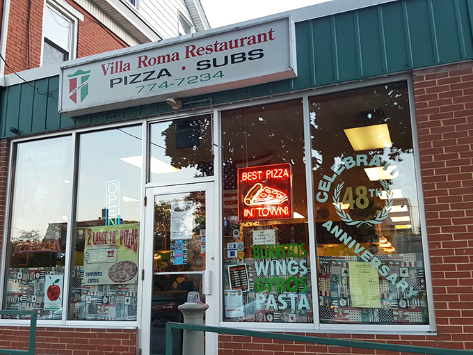 The unassuming storefront of Villa Roma might not stop traffic, but locals know this humble facade hides pizza treasures worth their weight in gold.