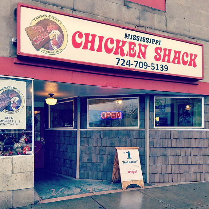 Another angle of this unassuming storefront that houses culinary magic. The "$1 Wings" sign might be the best deal in Beaver Falls.