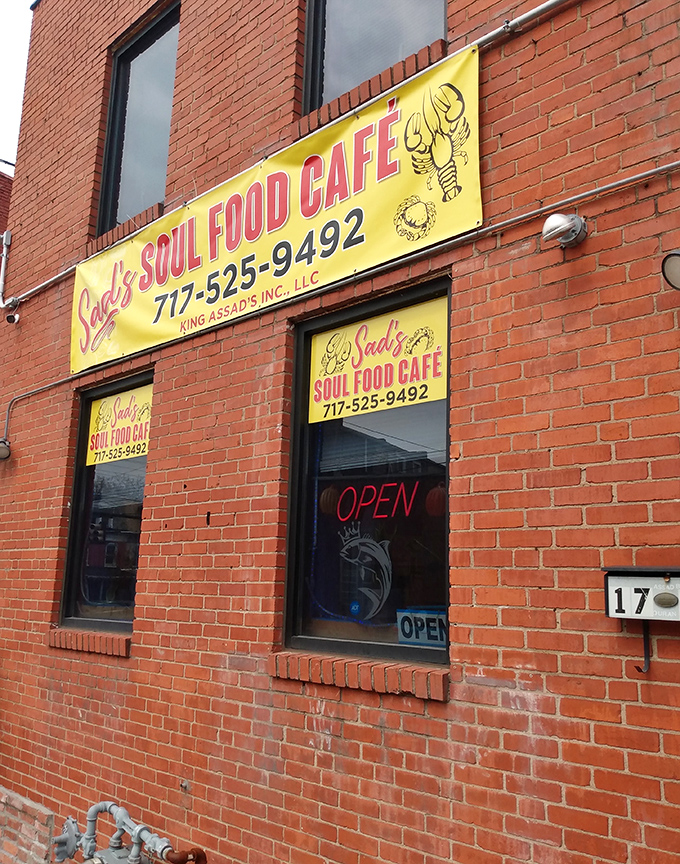 The unassuming brick exterior of Sad's Soul Food Cafe stands like a sentinel of flavor, promising culinary treasures behind that bright yellow sign.