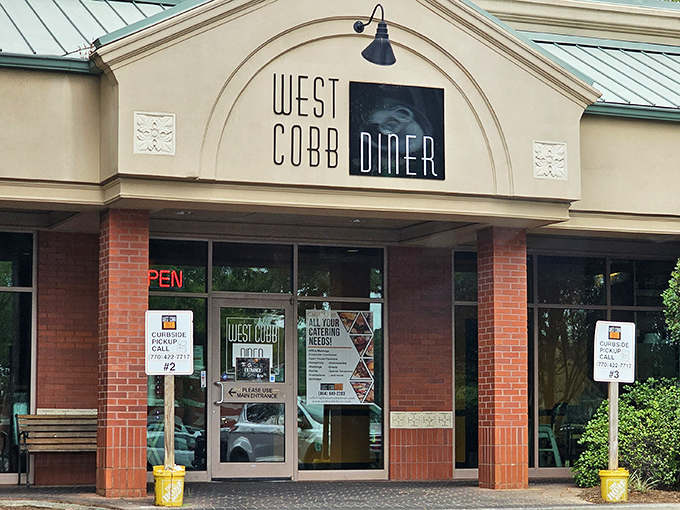 The unassuming exterior of West Cobb Diner proves once again that culinary treasures often hide in plain sight, nestled between Georgia pines. 
