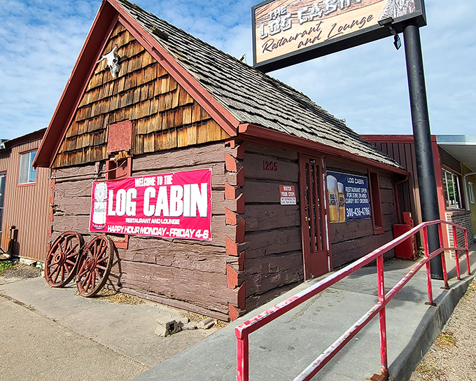 The iconic Log Cabin exterior stands like a time capsule, complete with rustic wooden shingles and vintage wagon wheels.