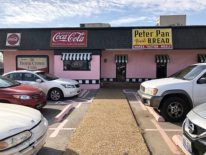 Morning sunshine meets bubblegum pink at Sherri's exterior, where the black and white checkered trim promises a classic diner experience inside.