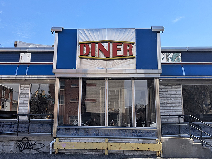 The iconic blue and silver façade of Broad Street Diner stands as a beacon of breakfast hope in South Philly, promising comfort food and conversations.