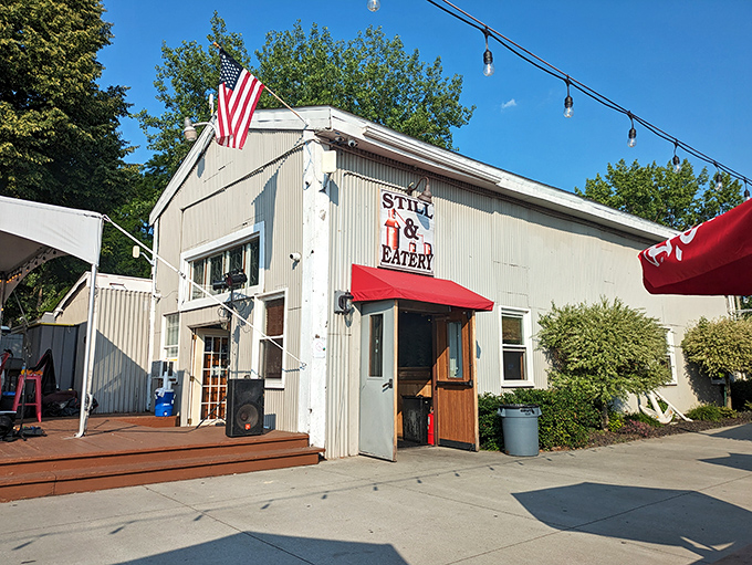 The corrugated metal exterior might scream "industrial chic," but that American flag and bright red awning whisper "come on in, the food's waiting."