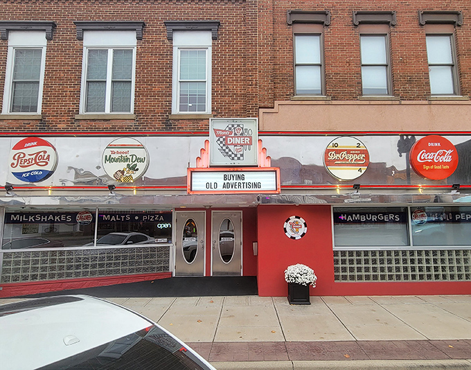 The classic red and brick facade of Mom's Diner & Pizzeria stands as a time capsule on Archbold's main street, complete with vintage soda signs that promise nostalgia by the plateful.