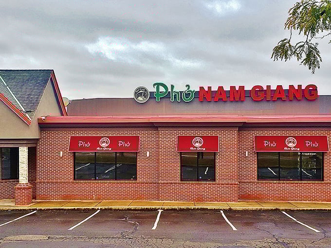 The red lettering of Pho Nam Giang stands out like a culinary lighthouse, beckoning hungry travelers with promises of Vietnamese comfort food.