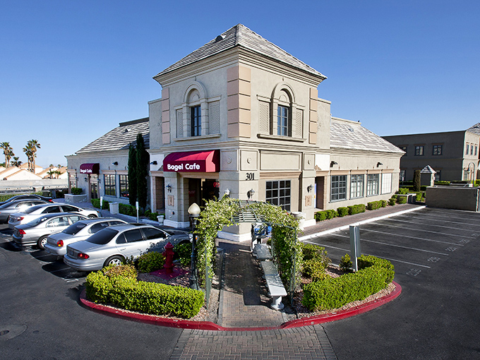 The Bagel Cafe's elegant exterior stands like a delicious mirage in the desert, promising New York deli delights with Vegas flair.