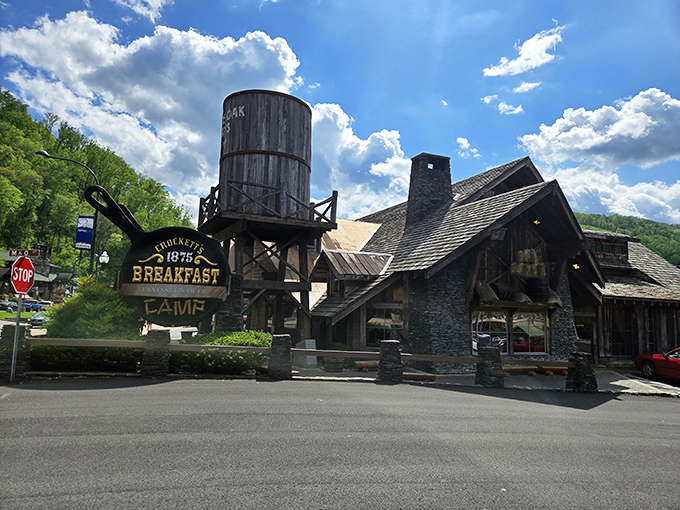 The rustic frontier charm of Crockett's Breakfast Camp stands proudly against Tennessee's blue skies, that water tower announcing "serious breakfast ahead" to hungry travelers.