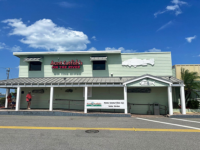 The pale yellow exterior of Aunt Catfish's welcomes you like an old friend, complete with that iconic fish silhouette promising seafood treasures within.