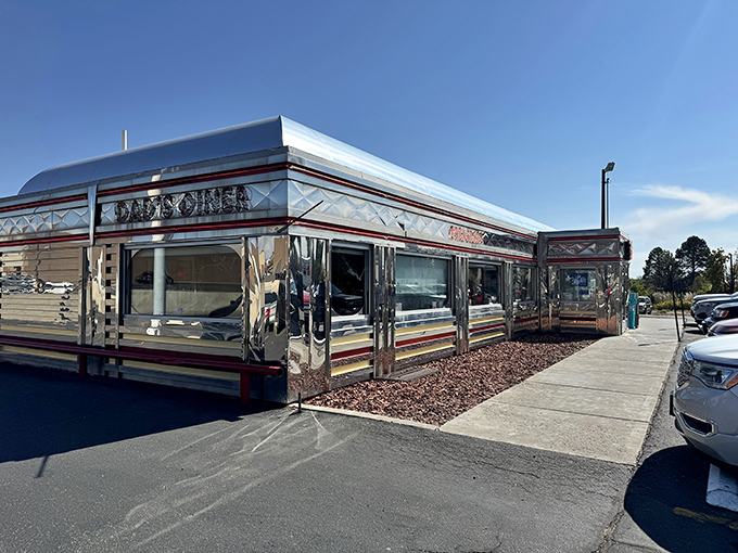 The gleaming stainless steel exterior of Dad's Diner shines like a time machine to the 1950s, beckoning hungry travelers with promises of classic American comfort.