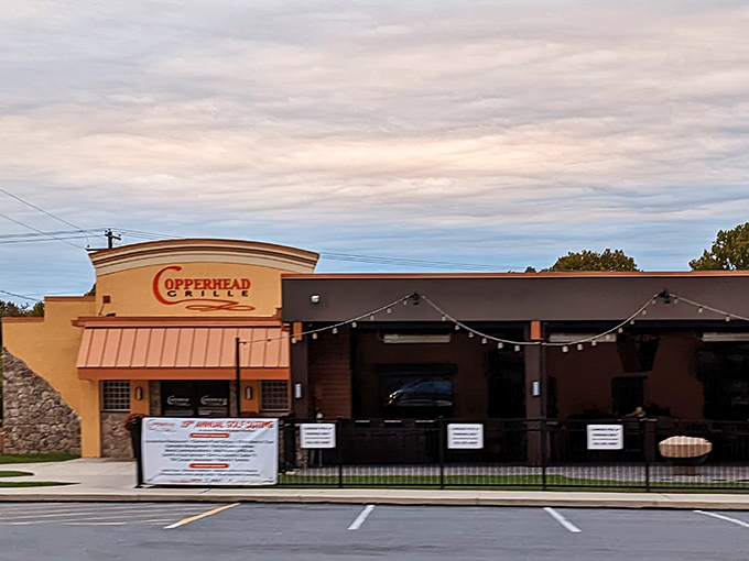 The warm glow of Copperhead Grille beckons like an oasis for the hungry traveler. String lights hint at the convivial atmosphere waiting inside.
