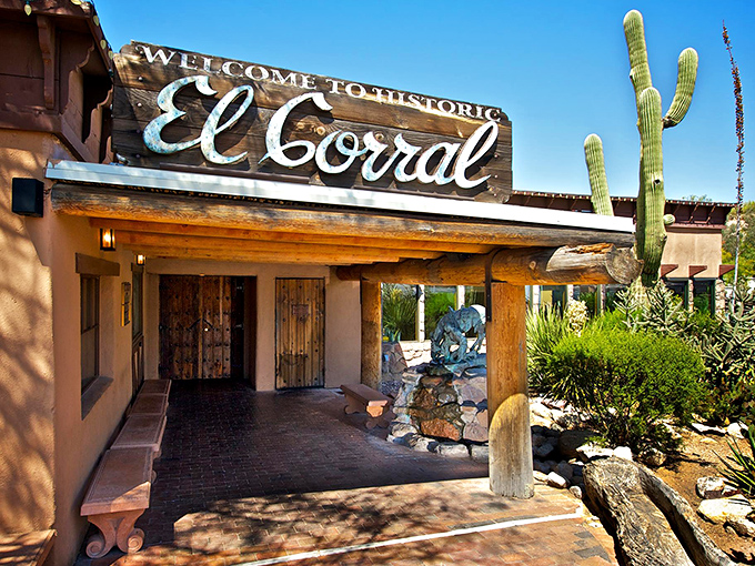 The entrance to El Corral stands like a time portal to the Old West, where saguaro sentinels have guarded this Tucson treasure since 1939.