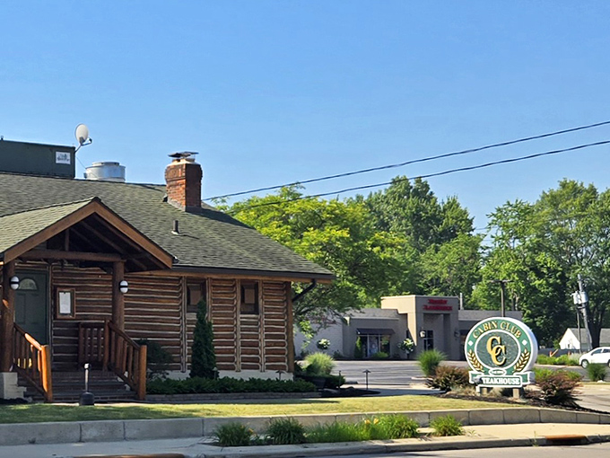 The rustic log cabin exterior of Cabin Club stands like a woodland mirage amid suburban Westlake, promising comfort and culinary adventure within its timber walls.