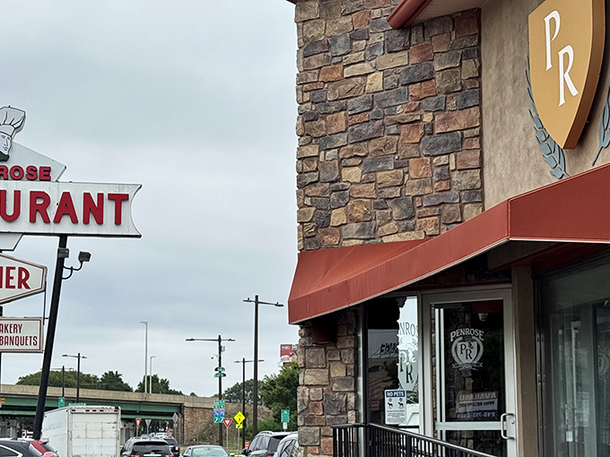 The iconic Penrose sign stands like a lighthouse for hungry travelers, promising comfort food salvation just off the South Philly streets.