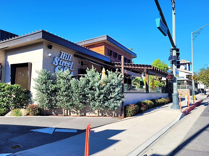 Hill Street Cafe's inviting exterior welcomes you with lush greenery and a covered patio. The perfect neighborhood spot where comfort food dreams come true.