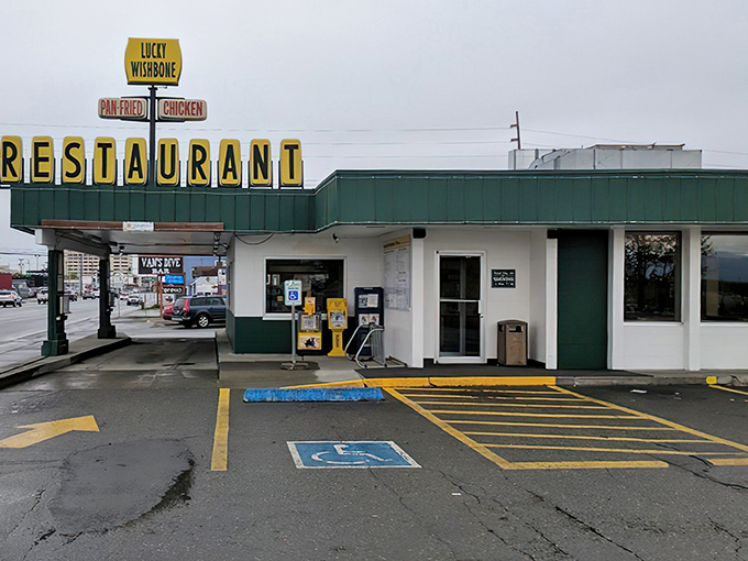 The iconic yellow Lucky Wishbone sign stands as a beacon of fried chicken perfection, promising pan-fried delights that have kept Anchorage coming back for generations.