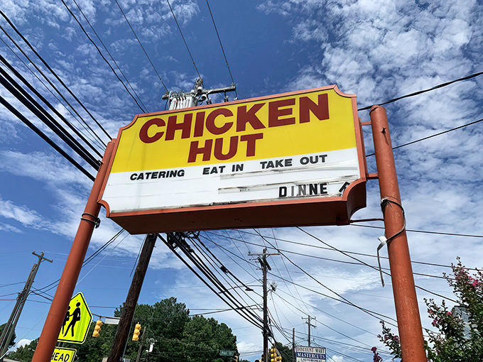 That iconic yellow sign against Carolina blue skies promises salvation for hungry souls. The Chicken Hut doesn't need fancy advertising when the food speaks this loudly.