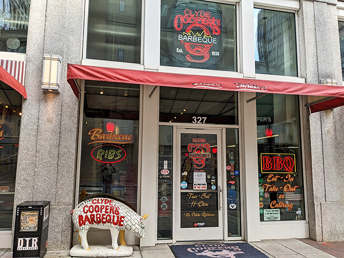The unassuming storefront of Clyde Cooper's, complete with a pig statue sentinel that seems to whisper, "Trust me, you want what's inside."