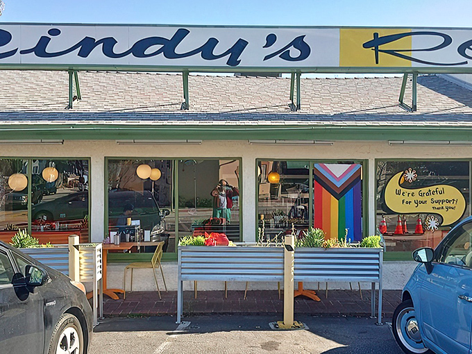 Cindy's proudly displays its community spirit with colorful window decorations, including a rainbow flag and gratitude message to loyal customers.