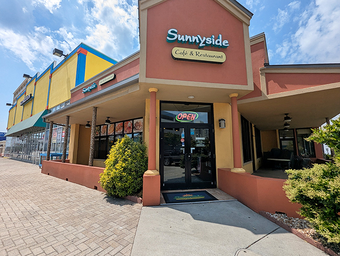 The peach-colored beacon of breakfast bliss beckons hungry travelers with its cheerful facade and promise of homestyle comfort food.