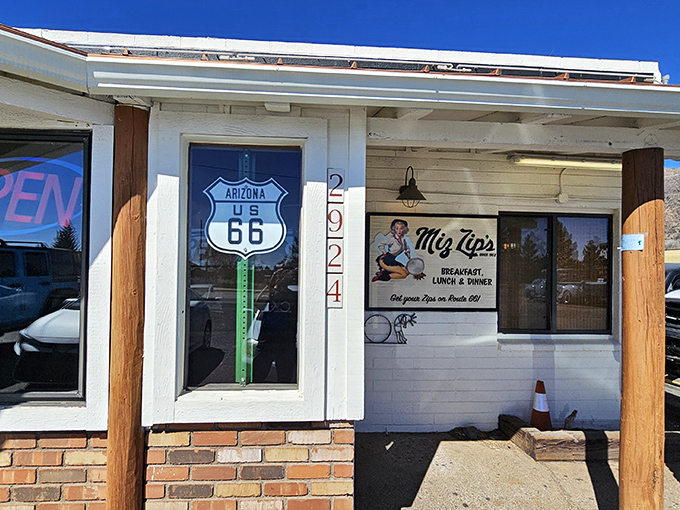 The classic Route 66 sign beckons hungry travelers to Miz Zip's, where time slows down and appetites perk up. A roadside promise of comfort since 1952.