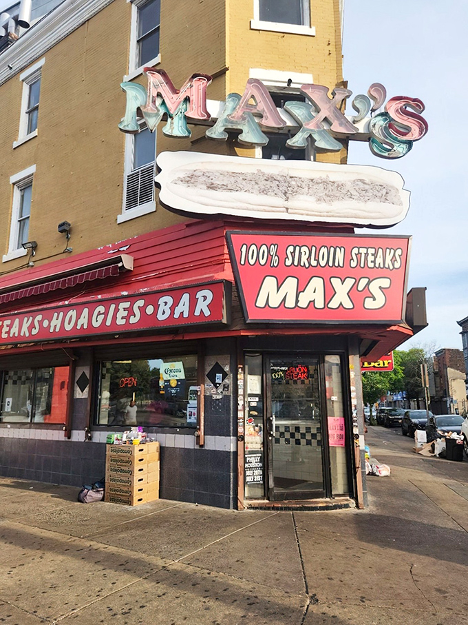 The iconic Max's Steaks sign glows like a neon North Star for sandwich pilgrims, promising "100% SIRLOIN STEAKS" with all the subtlety of a Philly sports fan.
