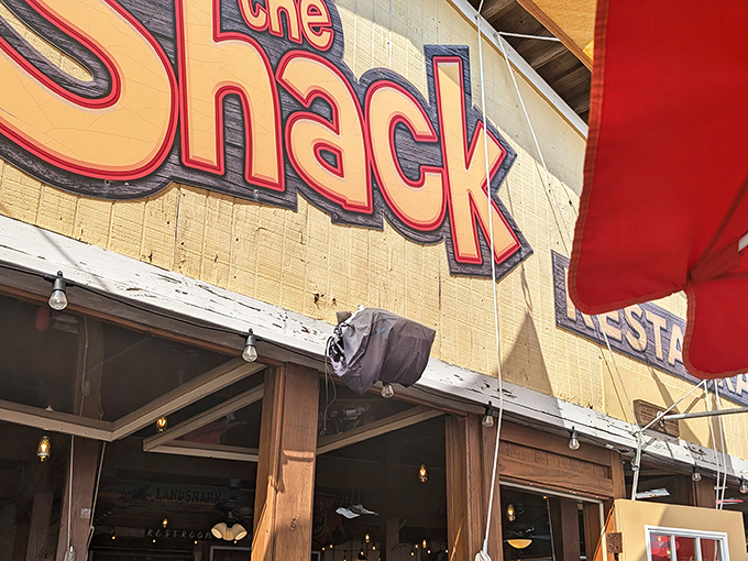 The iconic red lettering against weathered wood announces you've arrived somewhere authentic, not a place that needed a focus group to design its sign.