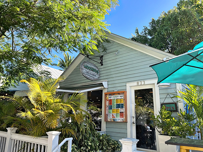 The turquoise facade of Moondog Cafe welcomes you like an old friend, its white picket railing and tropical foliage promising a true Key West experience.