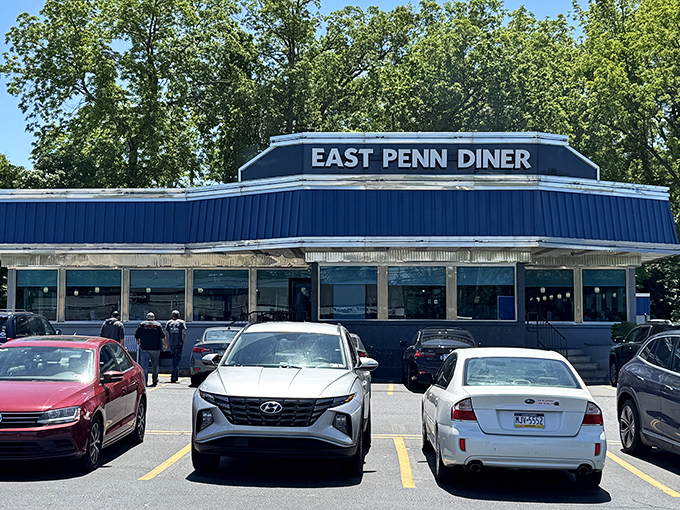 The iconic blue roof of East Penn Diner stands like a beacon of breakfast hope along Chestnut Street. Morning sunshine only enhances its classic American charm.