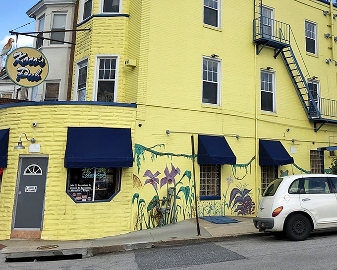 The sunshine-yellow exterior of Koco's Pub isn't just eye-catching—it's practically a lighthouse guiding hungry sailors to crab cake paradise in Baltimore's urban landscape.