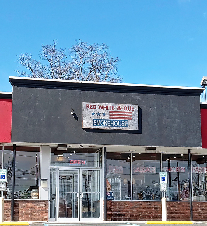 The weathered sign against that dark facade isn't just decoration&mdash;it's a promise of smoky delights waiting inside. No frills, just thrills for your taste buds.