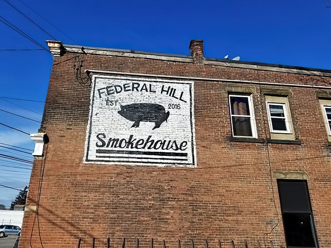 The iconic brick exterior of Federal Hill Smokehouse stands like a beacon to barbecue pilgrims, its simple pig logo promising smoky delights within.