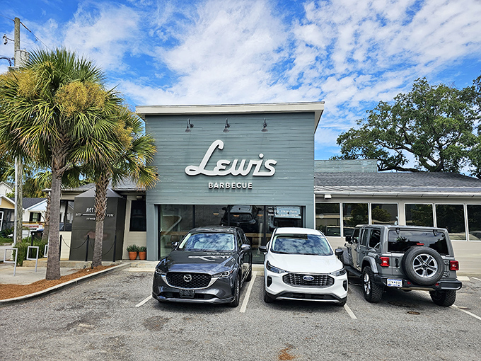 The sage-green sanctuary of Lewis Barbecue stands proudly against Charleston's blue sky, a Texas-sized promise of smoky delights waiting inside.