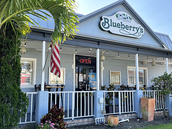 Blueberry's charming blue-and-white exterior welcomes hungry visitors like an old friend, complete with front porch seating and Florida's signature palm trees.