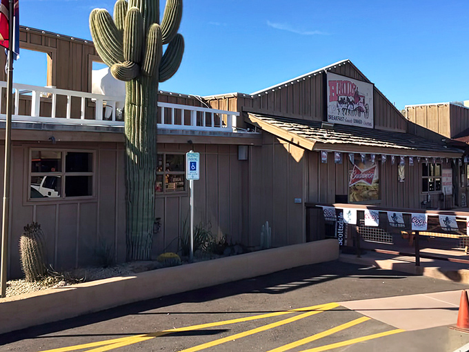A saguaro stands guard like nature's bouncer, welcoming you to Cave Creek's most beloved beef sanctuary.
