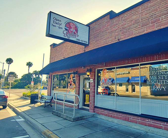 The brick facade and blue awning of Ruthy's Kozy Kitchen stand as a beacon for breakfast lovers in New Smyrna Beach. Morning sunshine included at no extra charge!