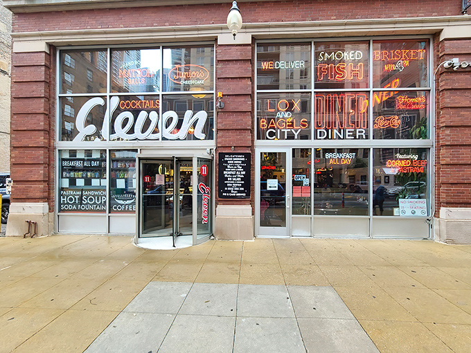Neon dreams come true at Eleven City Diner's storefront, where glowing signs promise delicatessen delights that would make your bubbe proud.