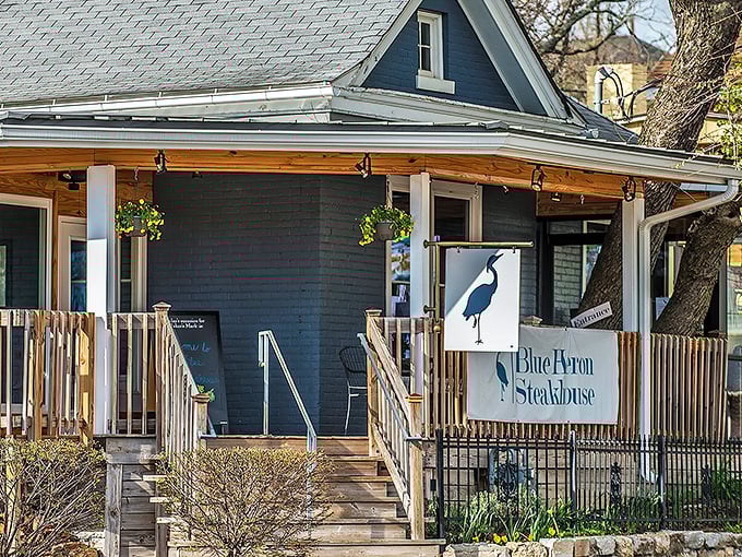 A Victorian cottage transformed into culinary heaven. The Blue Heron's charming blue exterior and welcoming porch promise Kentucky hospitality with big-city flavor.