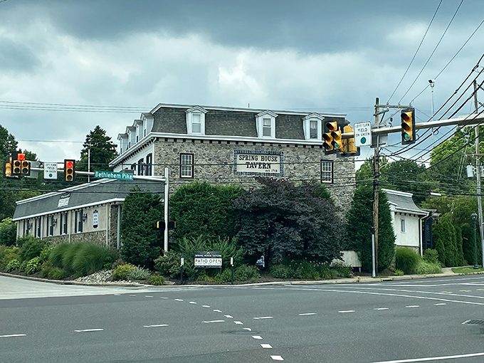 From this intersection view, Spring House Tavern commands attention like a colonial sentinel, its distinctive mansard roof and stone walls a landmark for hungry travelers.