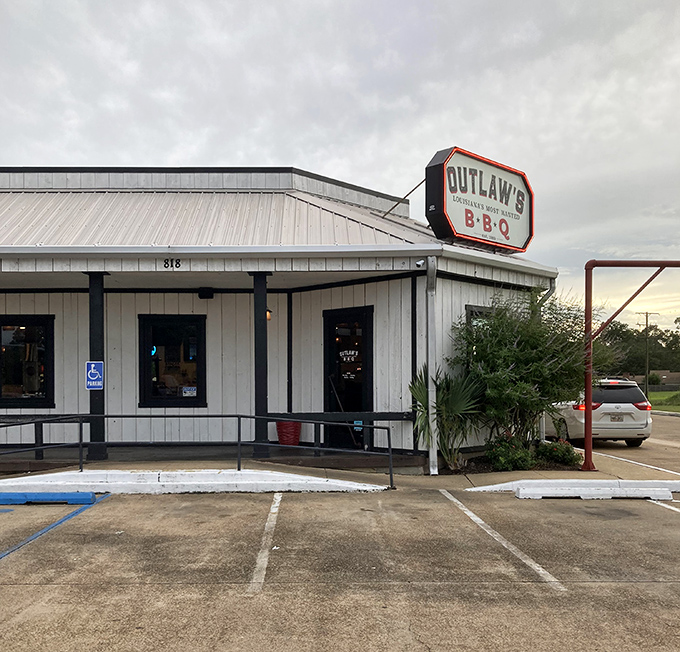 The classic white exterior of Outlaw's BBQ stands as a beacon for hungry travelers. Like a lighthouse, but guiding you to brisket instead of safe harbor.