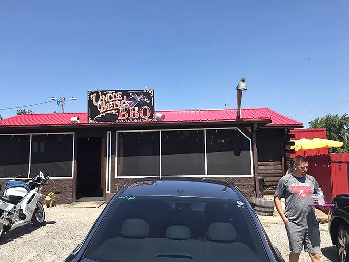The iconic sign beckons hungry travelers like a smoky North Star. Uncle Beth's BBQ promises carnivorous delights beneath that distinctive red roof.