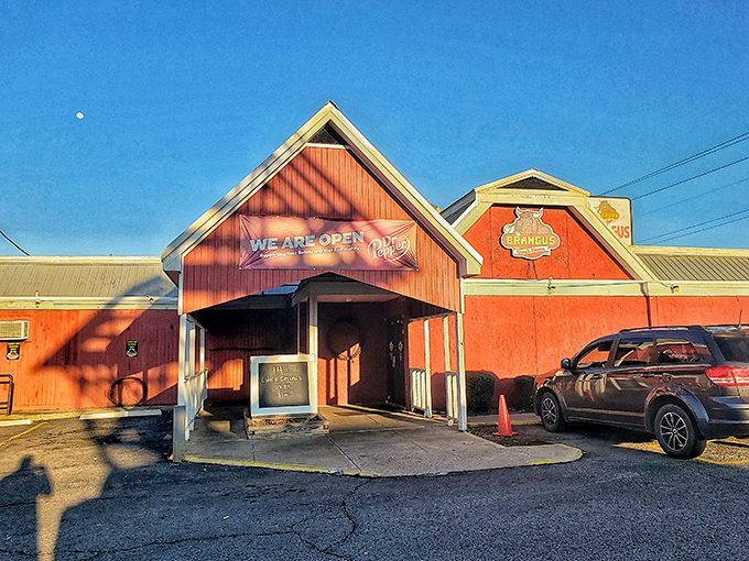 The barn-red exterior of Brangus Steakhouse stands proudly against the Arkansas sky, promising carnivorous delights within its unassuming walls.
