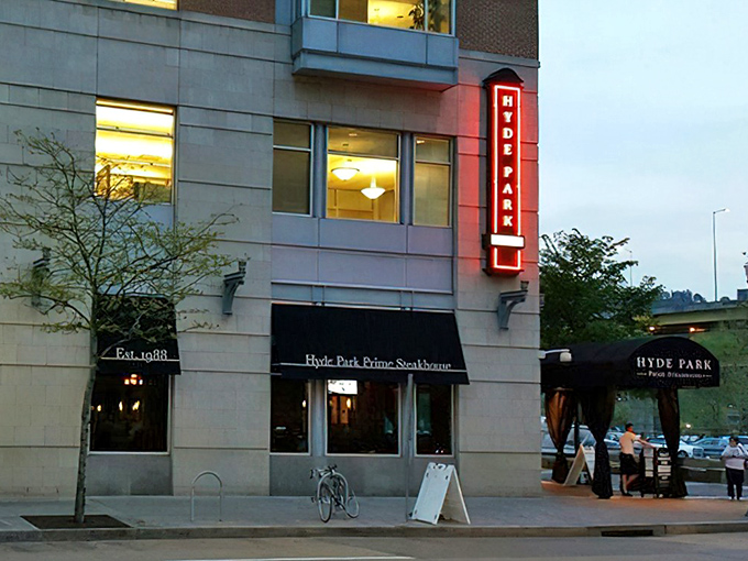Hyde Park's illuminated vertical sign stands tall against the Pittsburgh skyline, a beacon for those seeking serious steak satisfaction in the Steel City.