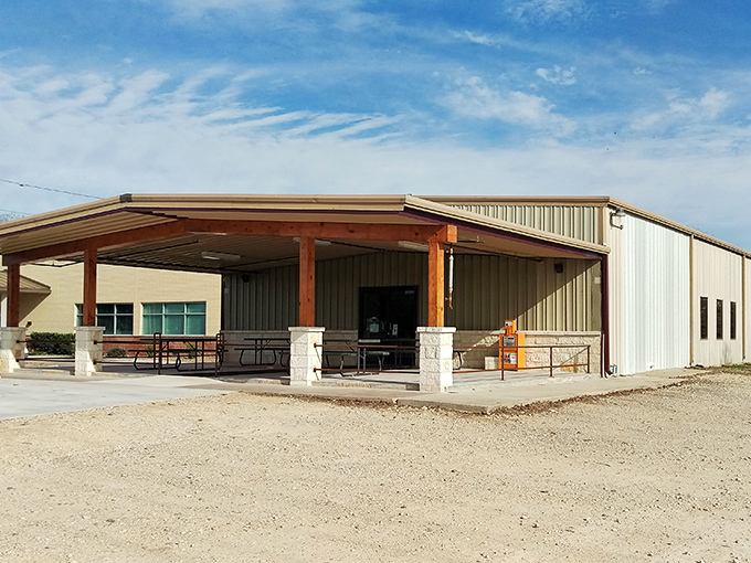 The unassuming exterior of Baker Boys BBQ&mdash;where Texas barbecue brilliance hides in a humble metal building, no frills necessary.