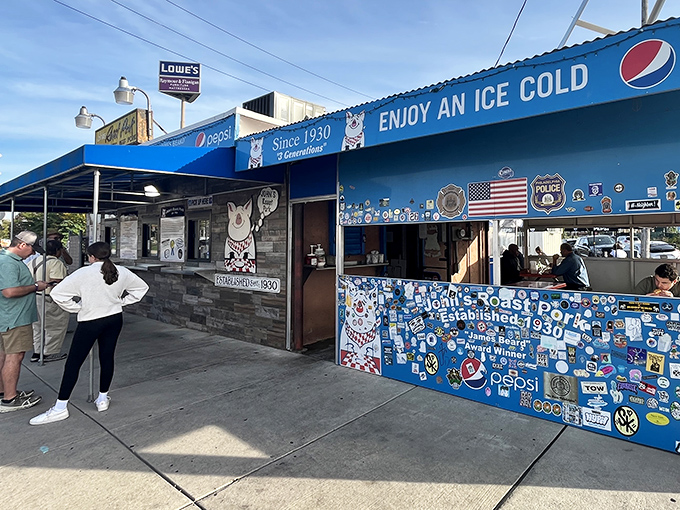 The blue exterior of John's Roast Pork stands like a culinary lighthouse in South Philly, beckoning sandwich pilgrims with its no-nonsense charm.