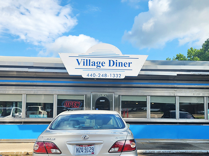 Classic Americana gleams in the Ohio sunshine. The Village Diner's chrome-and-blue exterior promises timeless comfort like a wink from the past.