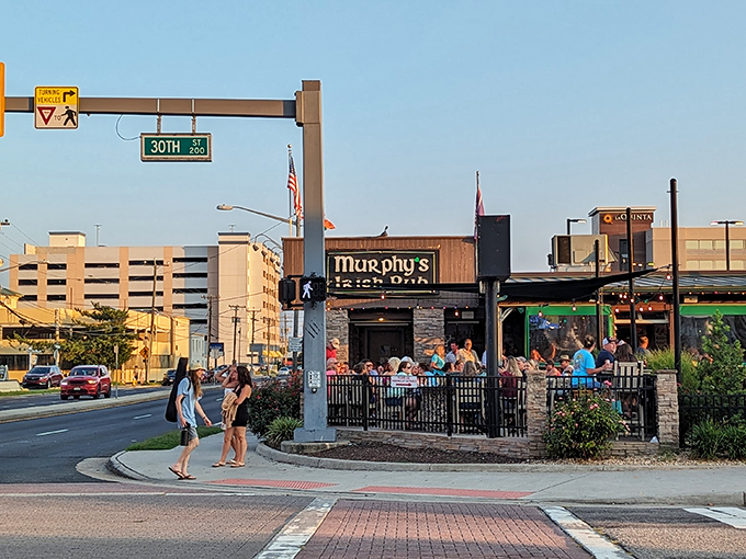 Murphy's Irish Pub, with its stone facade and Celtic lettering, buzzes with customers against the Virginia Beach skyline, offering authentic Irish comfort just steps from the Atlantic.